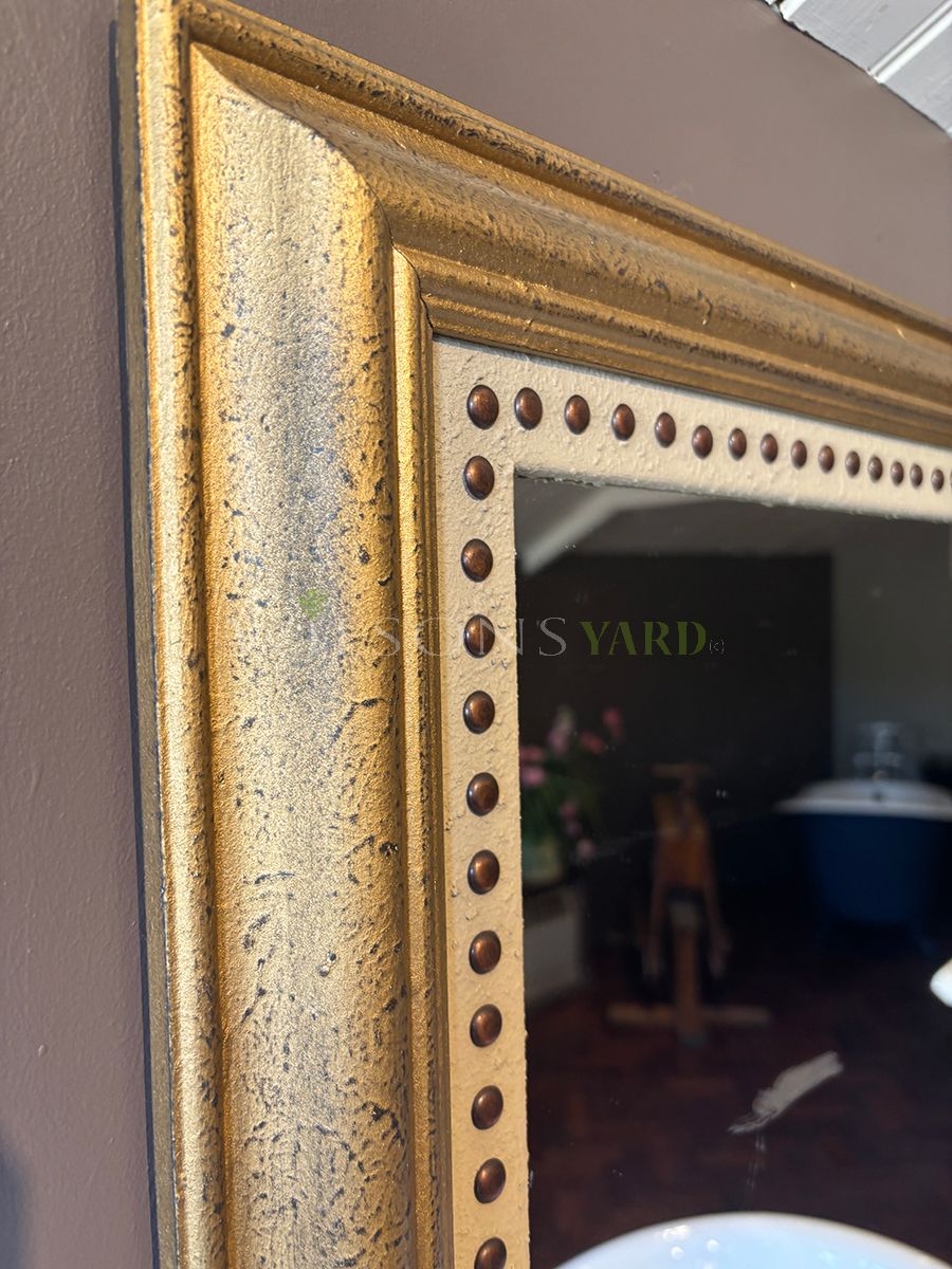 Stylish & studded gilt mirror